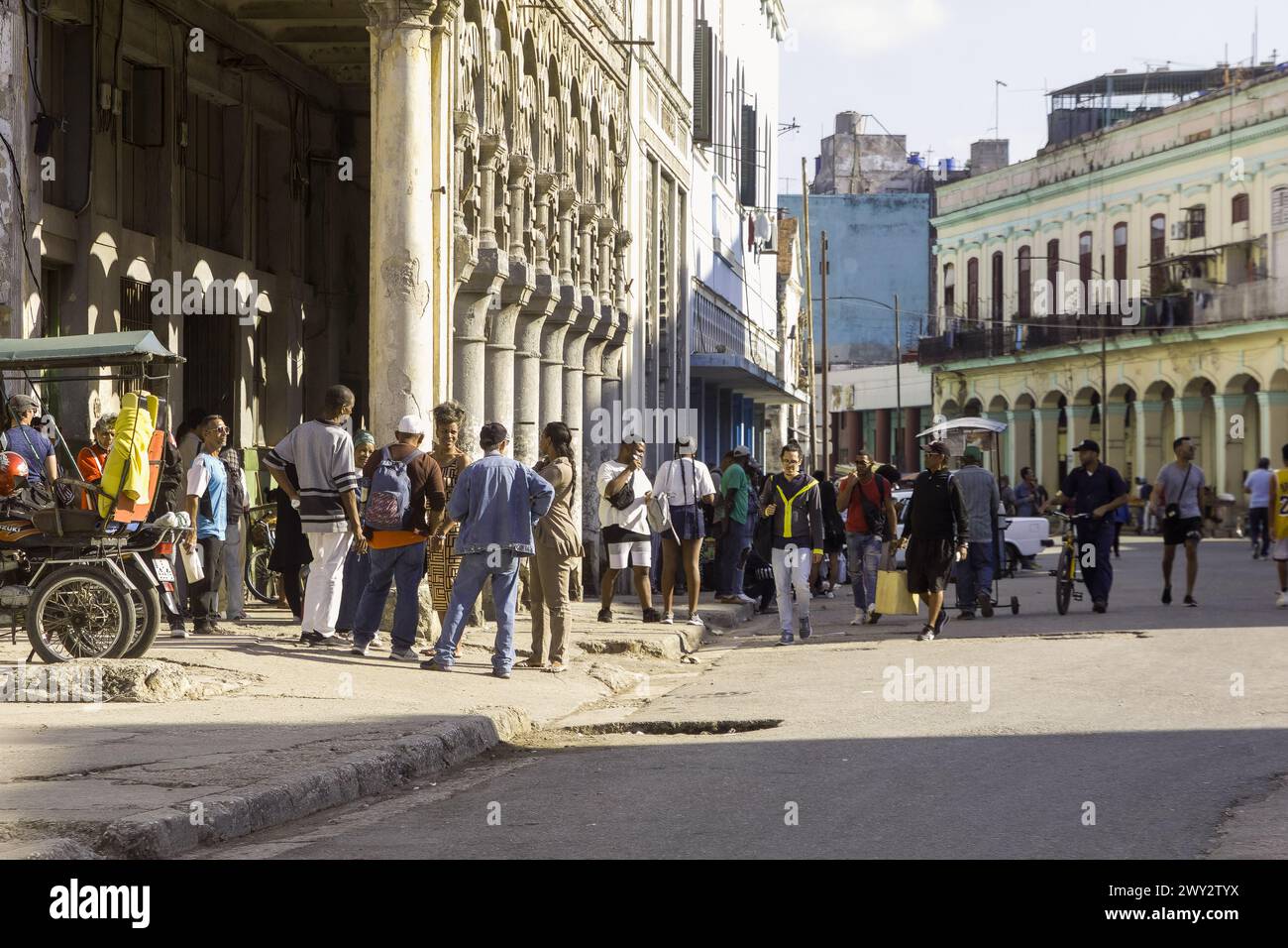 Cuban people lining-up by run-down buildings, Havana, Cuba Stock Photo ...