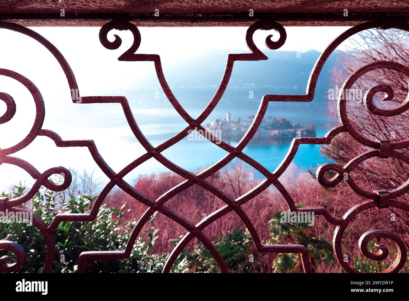 Wrought Iron Grating And St. Giulio Island. Charming view of St. Giulio ...