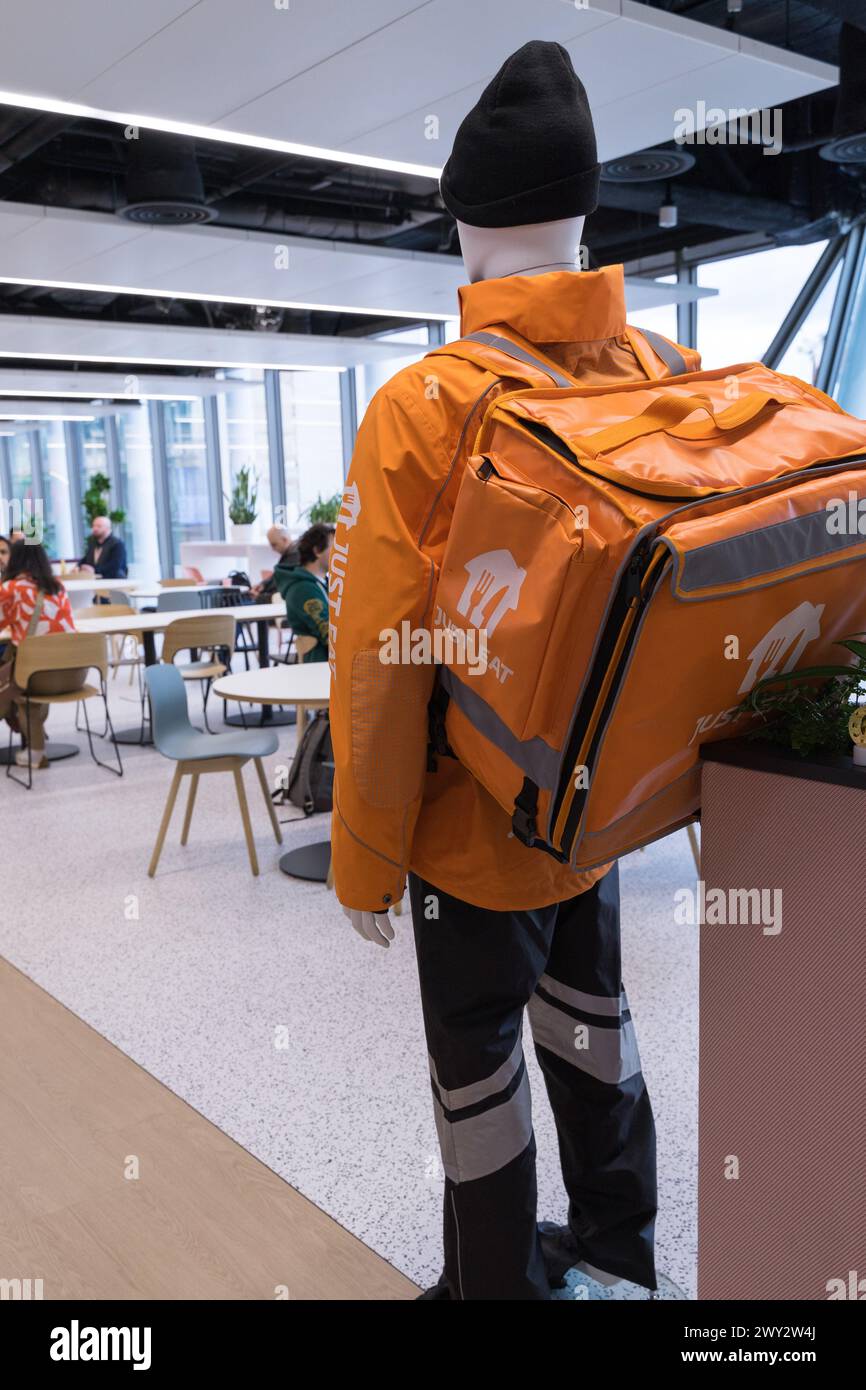 rear view of a fast food delivery man dressed in orange Just eat jacket ...
