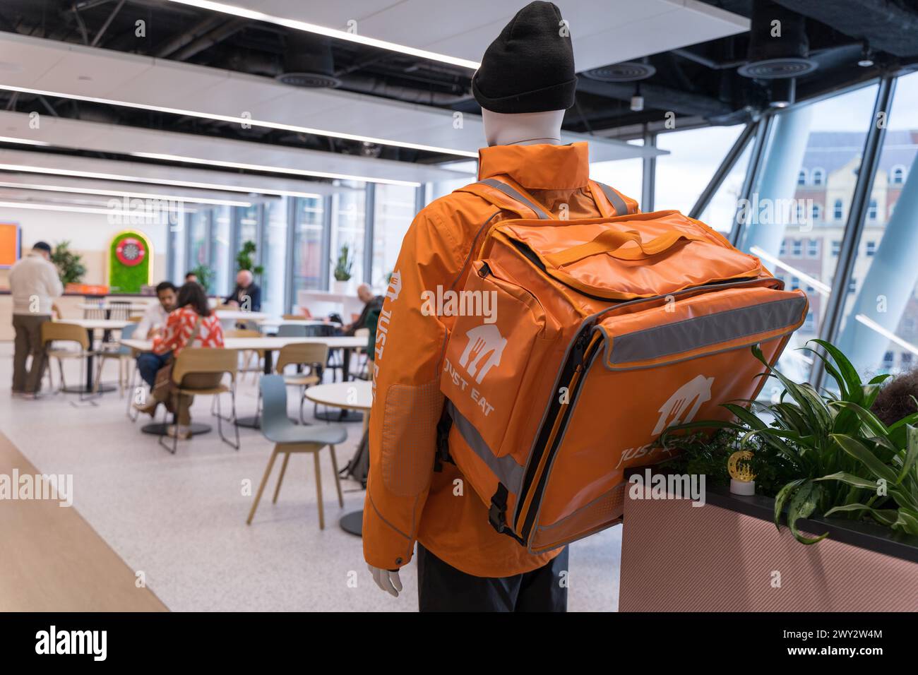 rear view of a fast food delivery man dressed in orange Just eat jacket ...