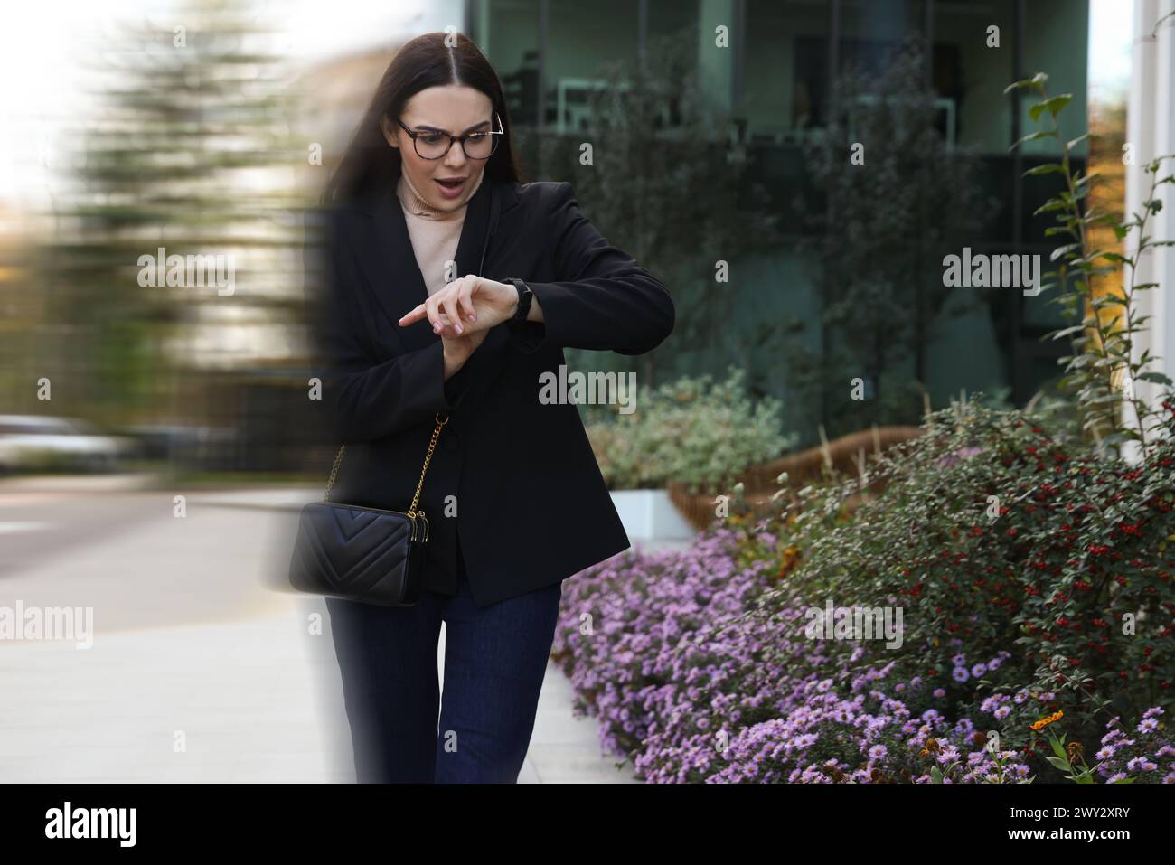 Being late. Woman in hurry checking time outdoors. Motion blur effect ...