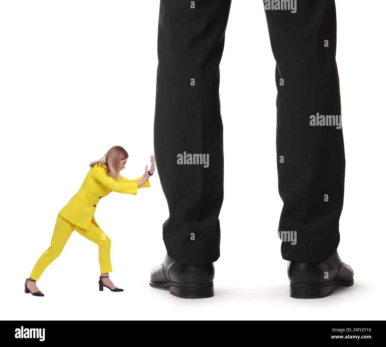 Small woman pushing giant man on white background Stock Photo - Alamy