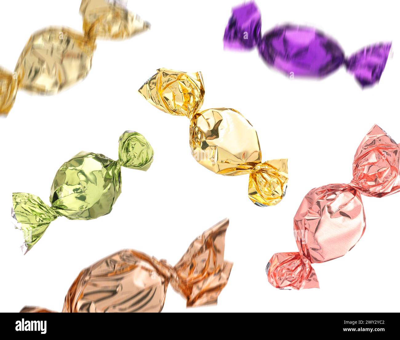 Candies in bright wrappers falling on white background Stock Photo - Alamy