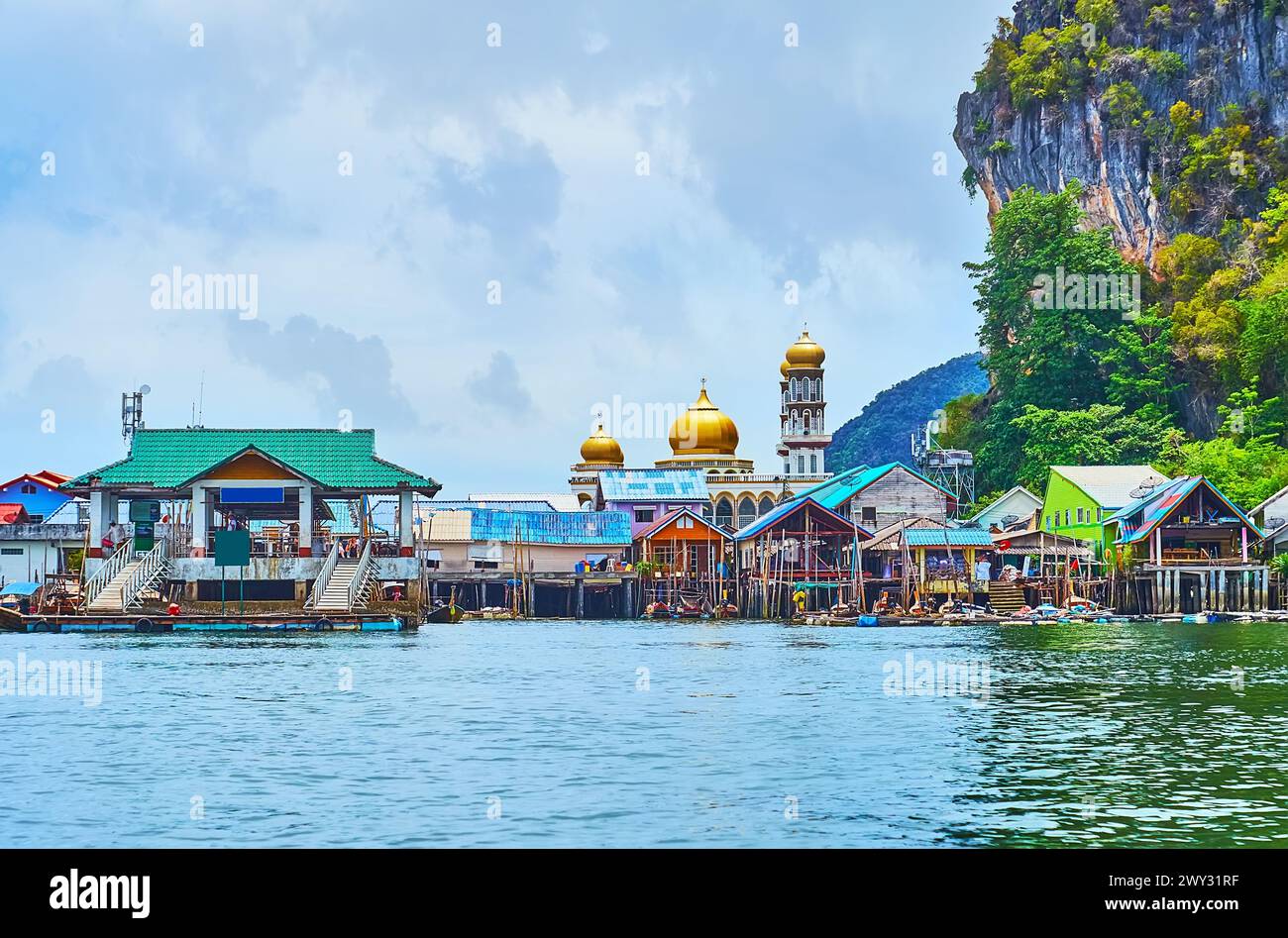 The stilt houses of Ko Panyi village at the foot of the rock, Phang Nga ...