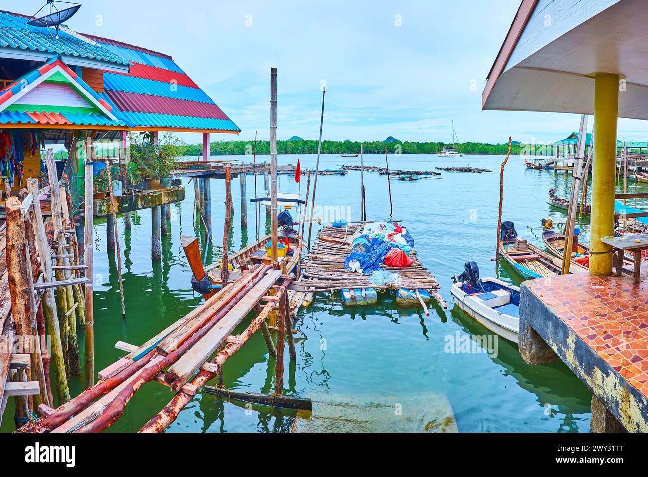 The rickety fishing pier, made of old sticks and rotten boards in Ko ...