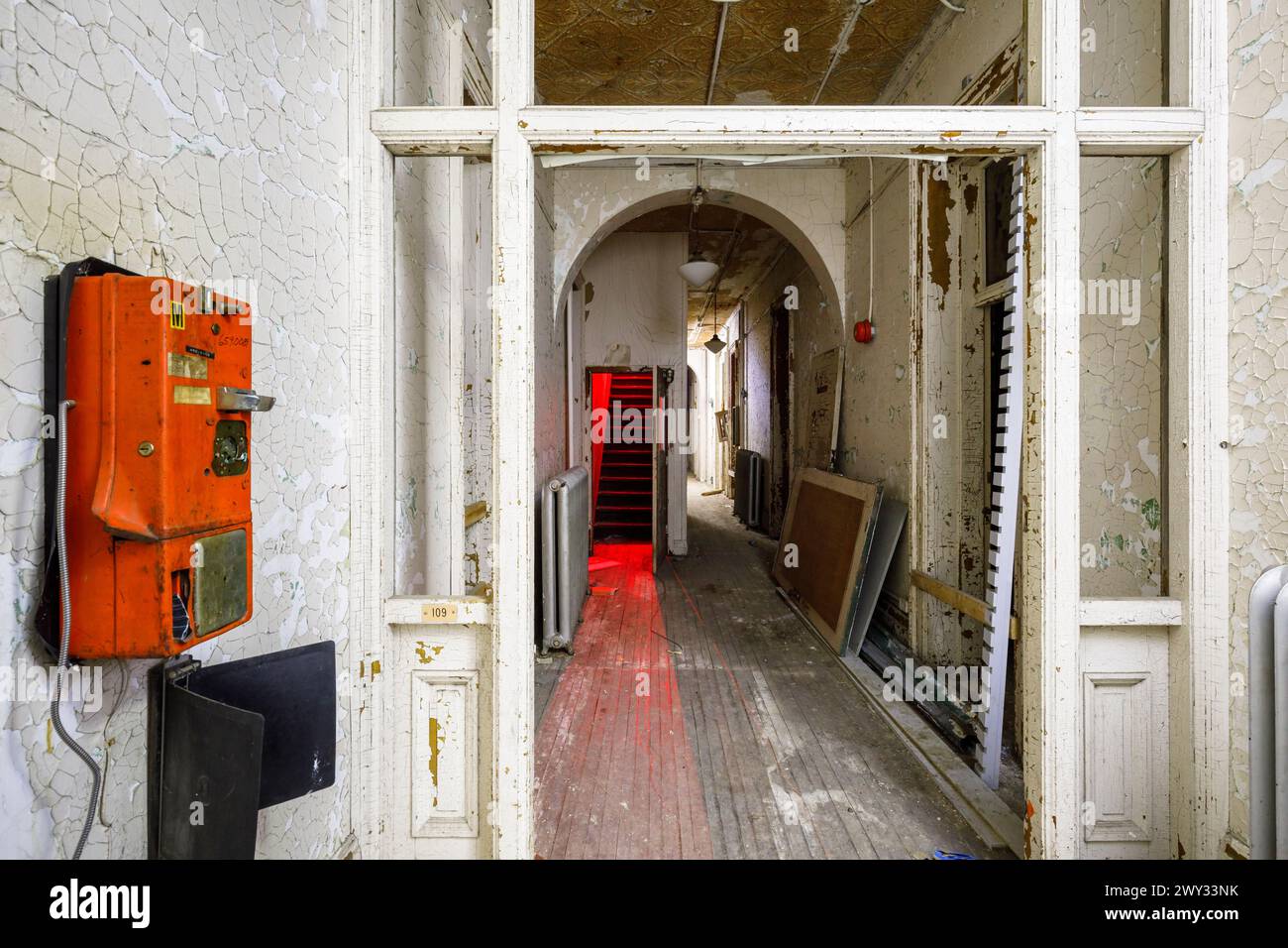 An old orange payphone and hallway inside the Infirmiry/Exam Building ...