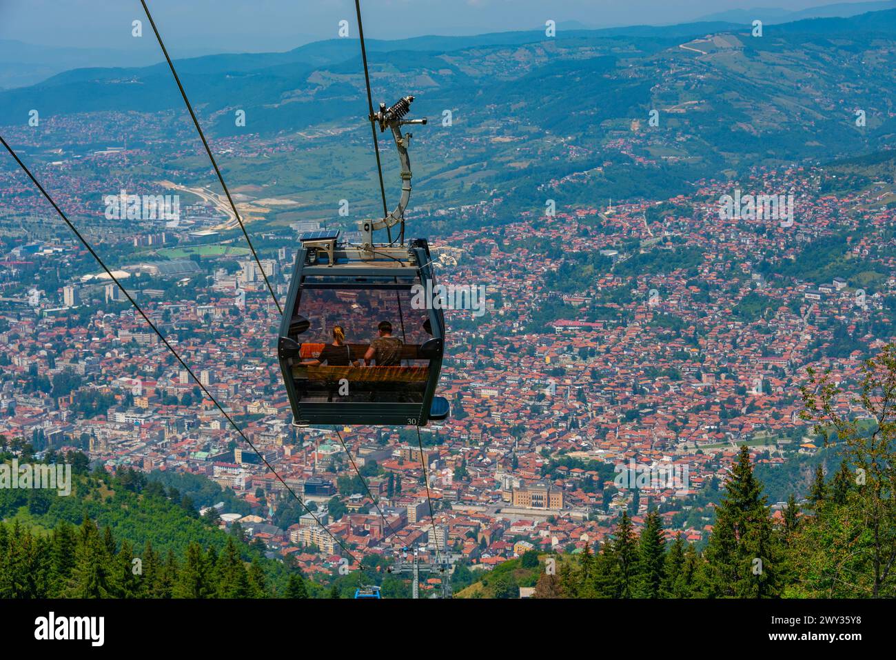 Trebevic gondola raising from the old town of Sarajevo, Bosnia and ...