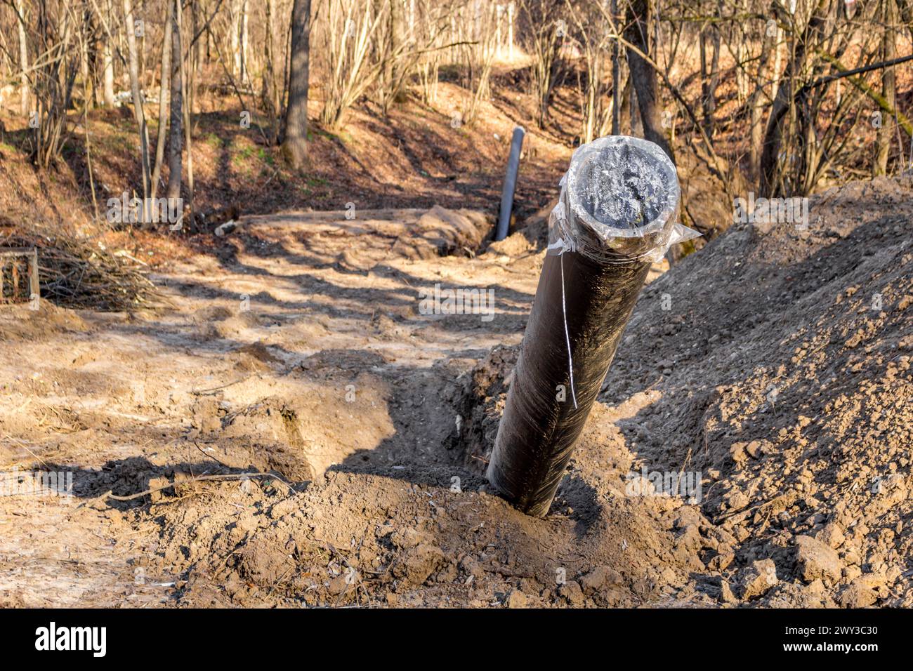 Plastic pipe laying in the ground, outdoor Stock Photo - Alamy