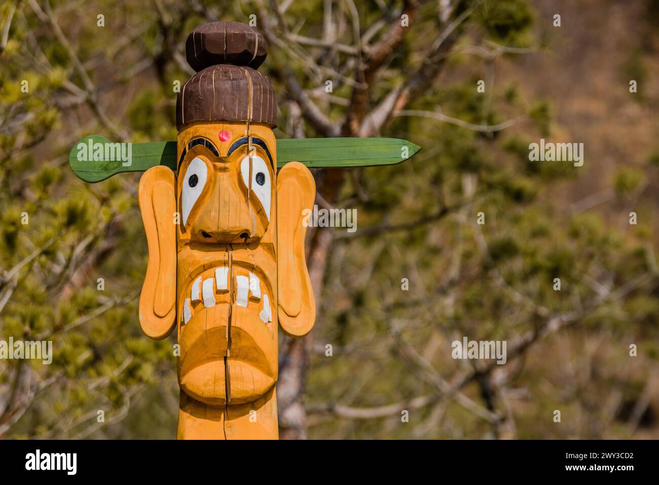 Closeup of carved face of wooden totem pole used long ago to protect ...