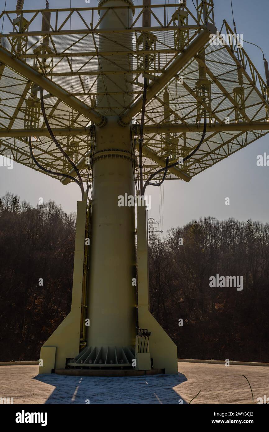 A large electrical transformer tower with a metal grid structure ...