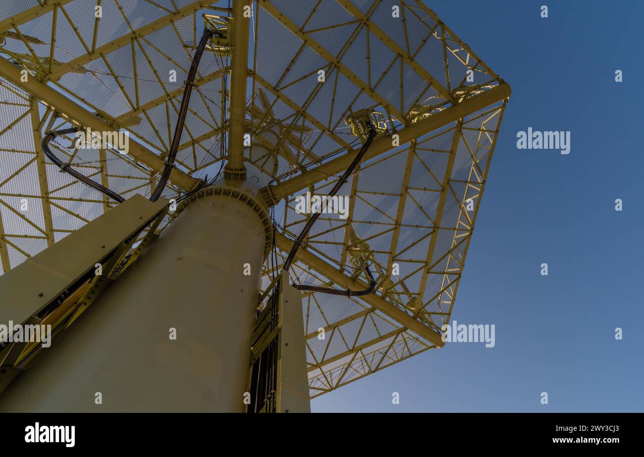 View looking up through electrical transformer tower against a bright ...