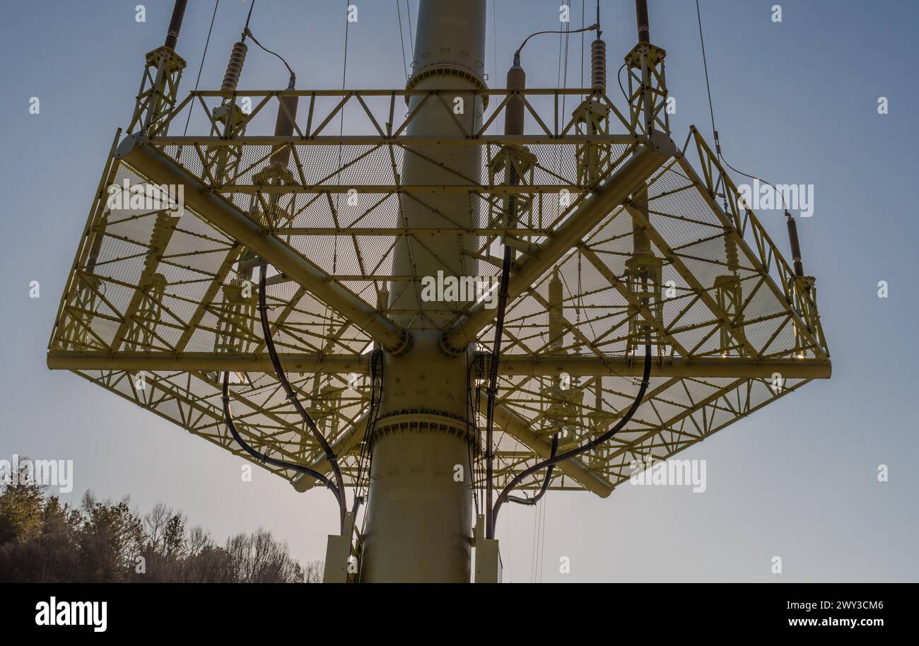 Low angle view of grid support of large electrical tower with sun ...