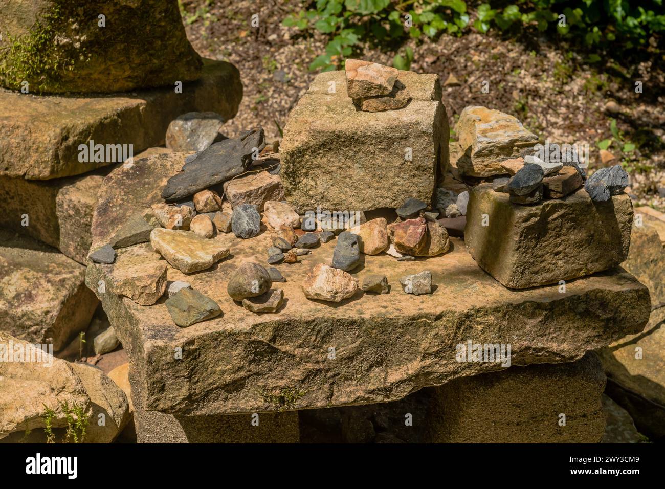 Small rocks on flat boulder part of rock garden in public park in South ...