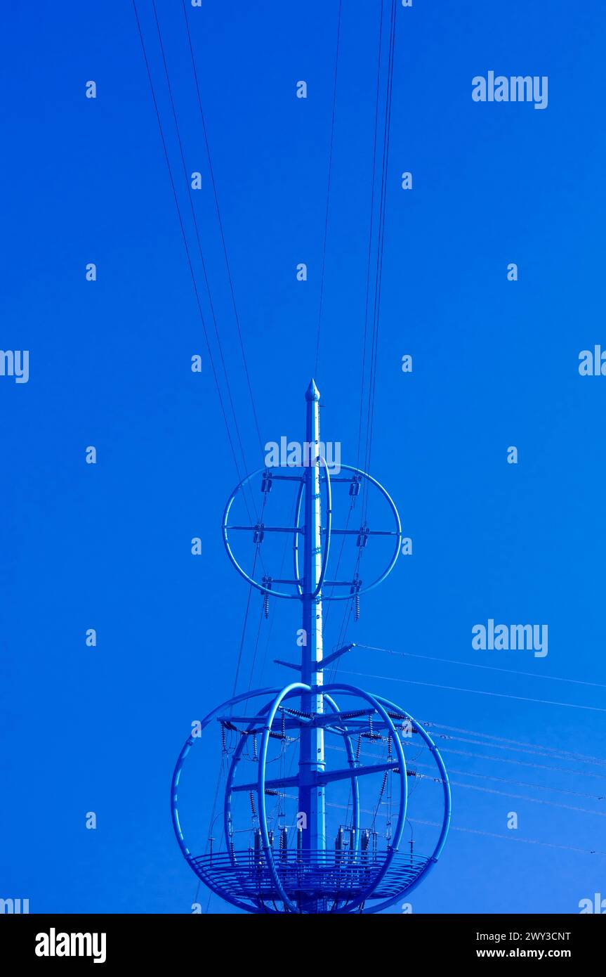 Large round, blue cable transition tower in blue evening sky as the sun ...