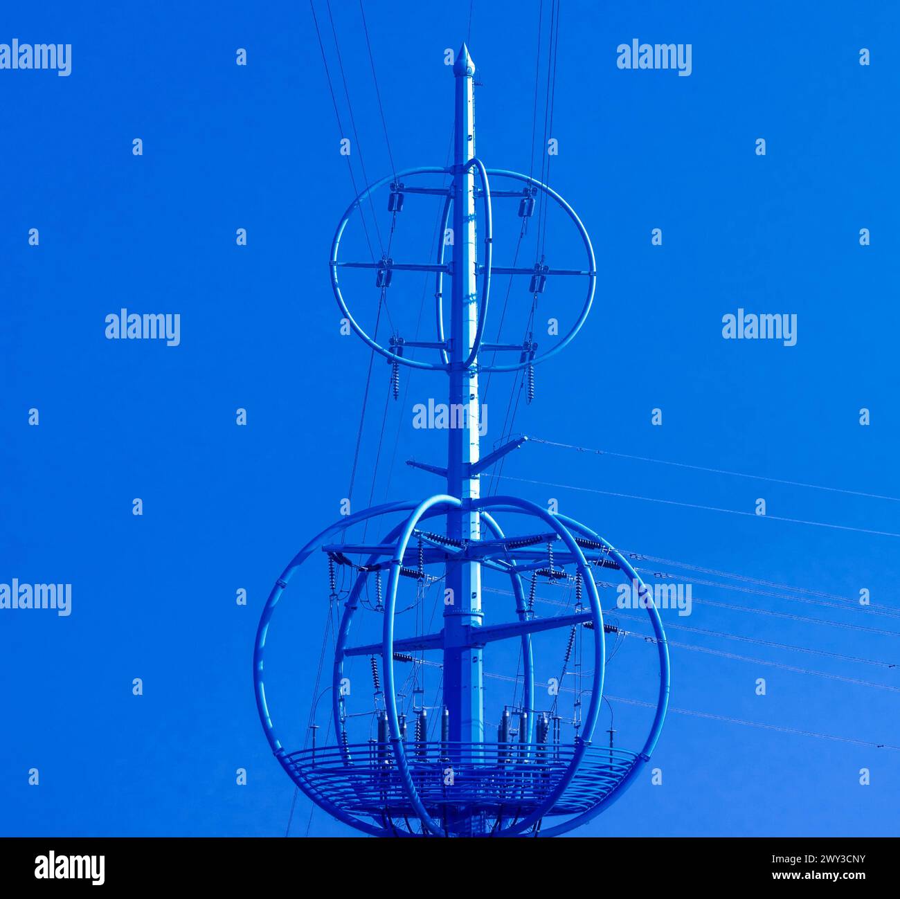 Large round, blue cable transition tower in blue evening sky as the sun ...