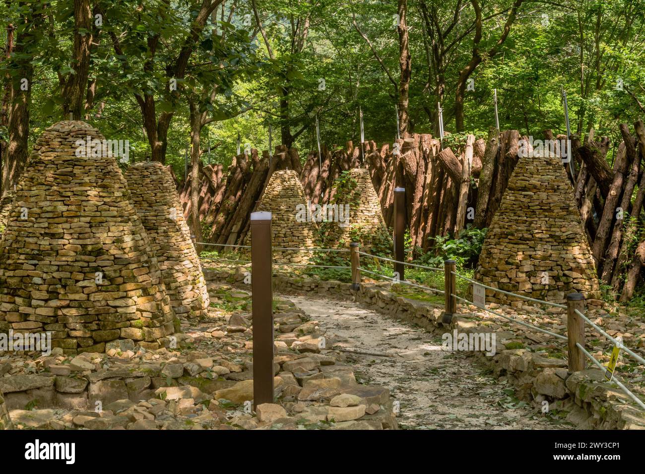 Walking path between two rows of cairns (stacks of stones) under shade ...