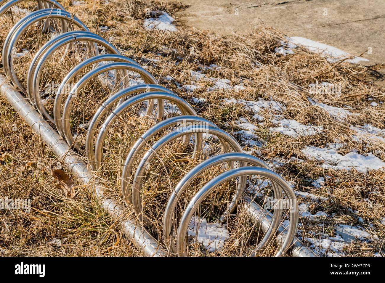 Chrome bicycle rack in dry grass on cold winter day in South Korea ...
