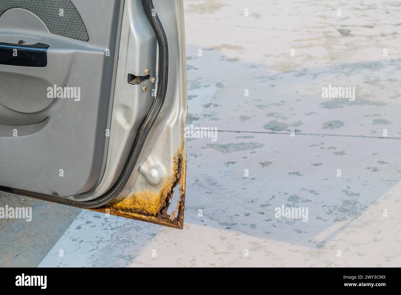 Hole where rust has eaten through the lower panel on passenger side ...