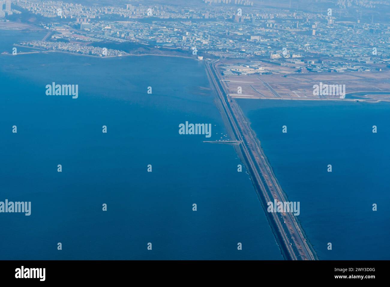 Aerial landscape of ocean causeway and leading to large on coast as ...