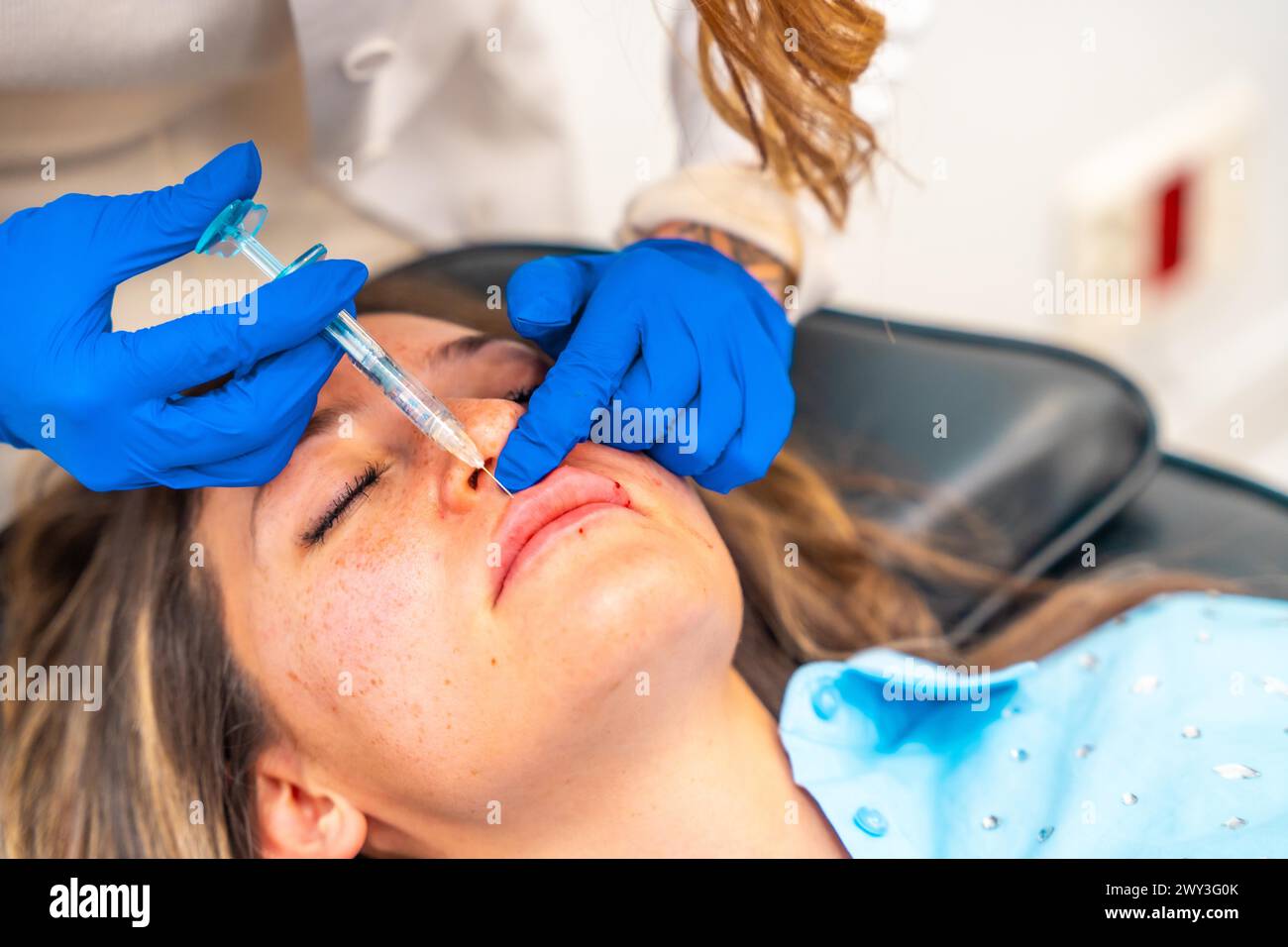 Close-up of a caucasian adult woman getting a Botox injection in the ...