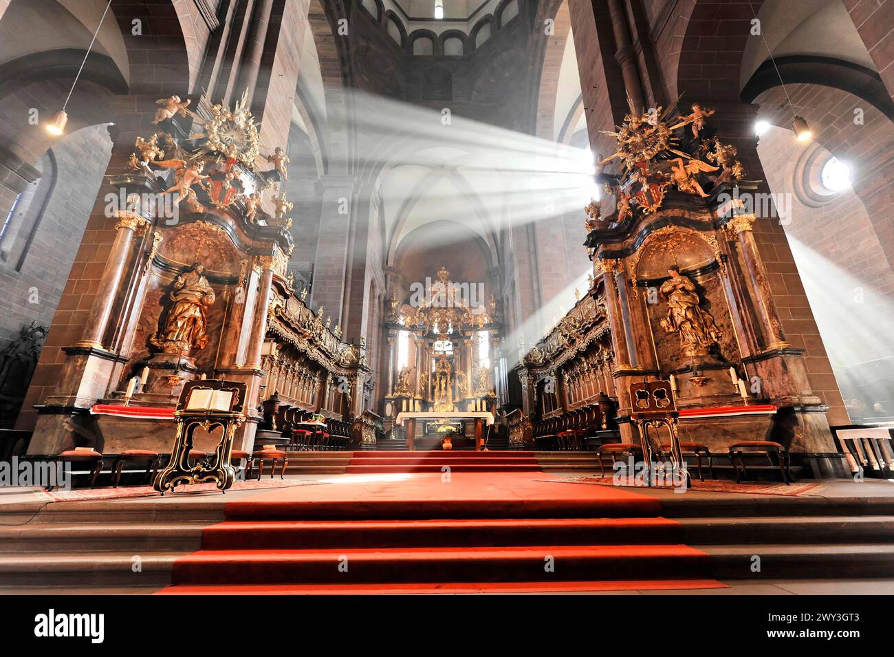 Speyer Cathedral, An impressive interior of a church with baroque altars and rays of light ...