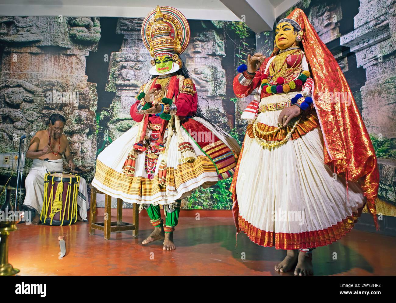 Kathakali performer or mime, 38 and 60 years old, and drummer on stage ...