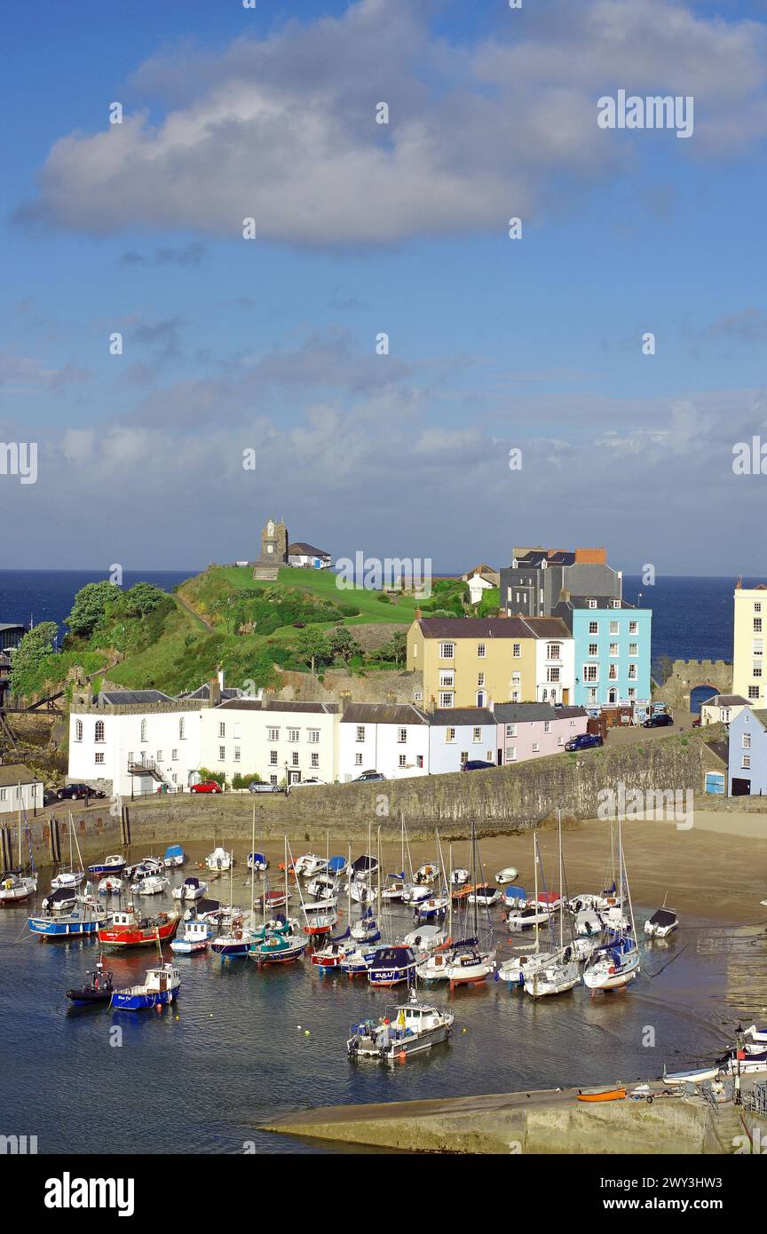 Small boats lying on a sandy beach, colourful houses, Tenby ...