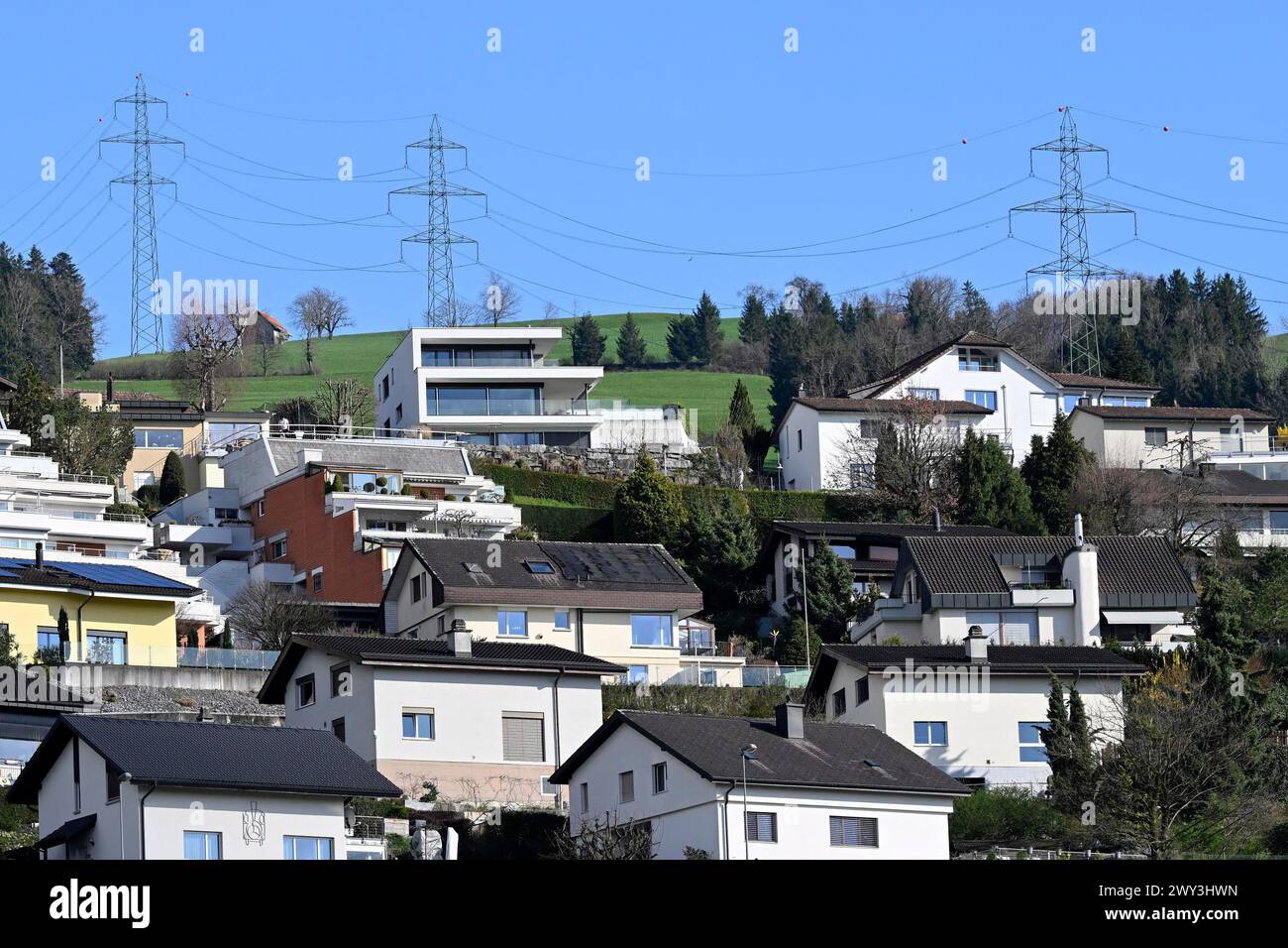 Multi-family houses on a slope with electricity pylons, Switzerland ...