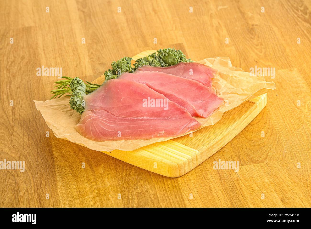 Raw salted tuna slice over board snack Stock Photo - Alamy