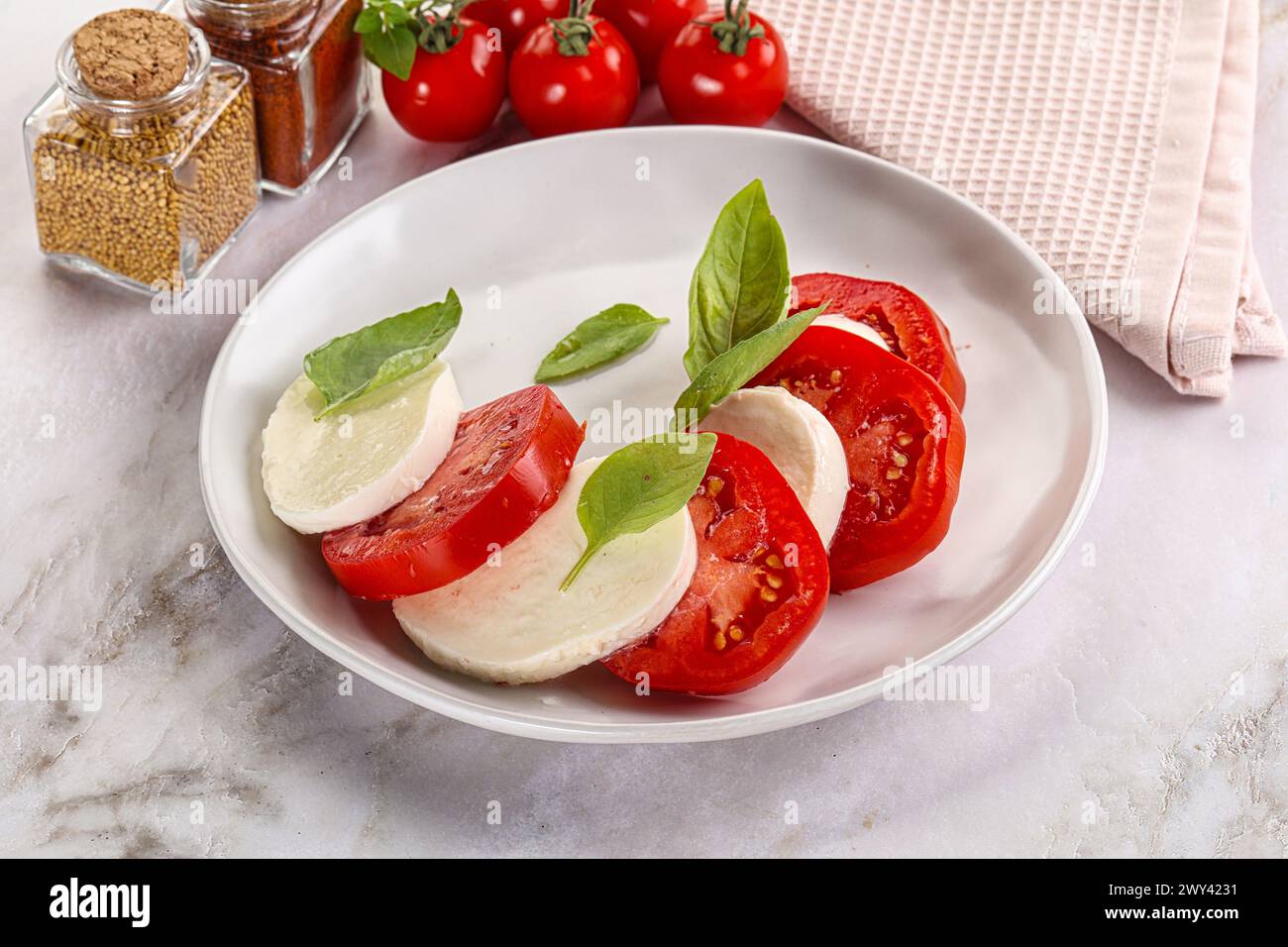 Italian caprese salad with mozzarella, tomato and basil Stock Photo - Alamy