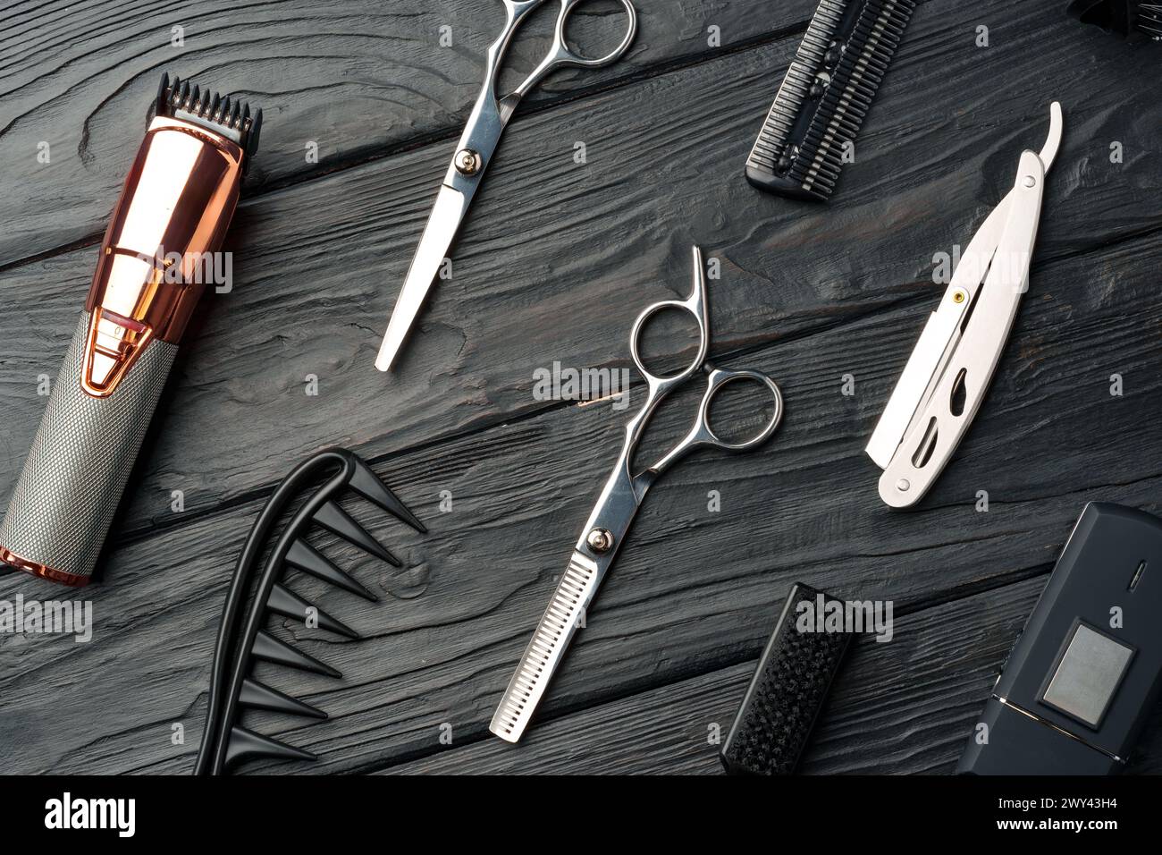 Professional Barber Tools Laid Out on Dark Wooden Surface Stock Photo ...