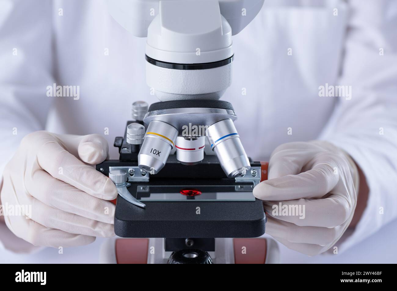 Scientist researching blood sample by microscope in laboratory closeup ...