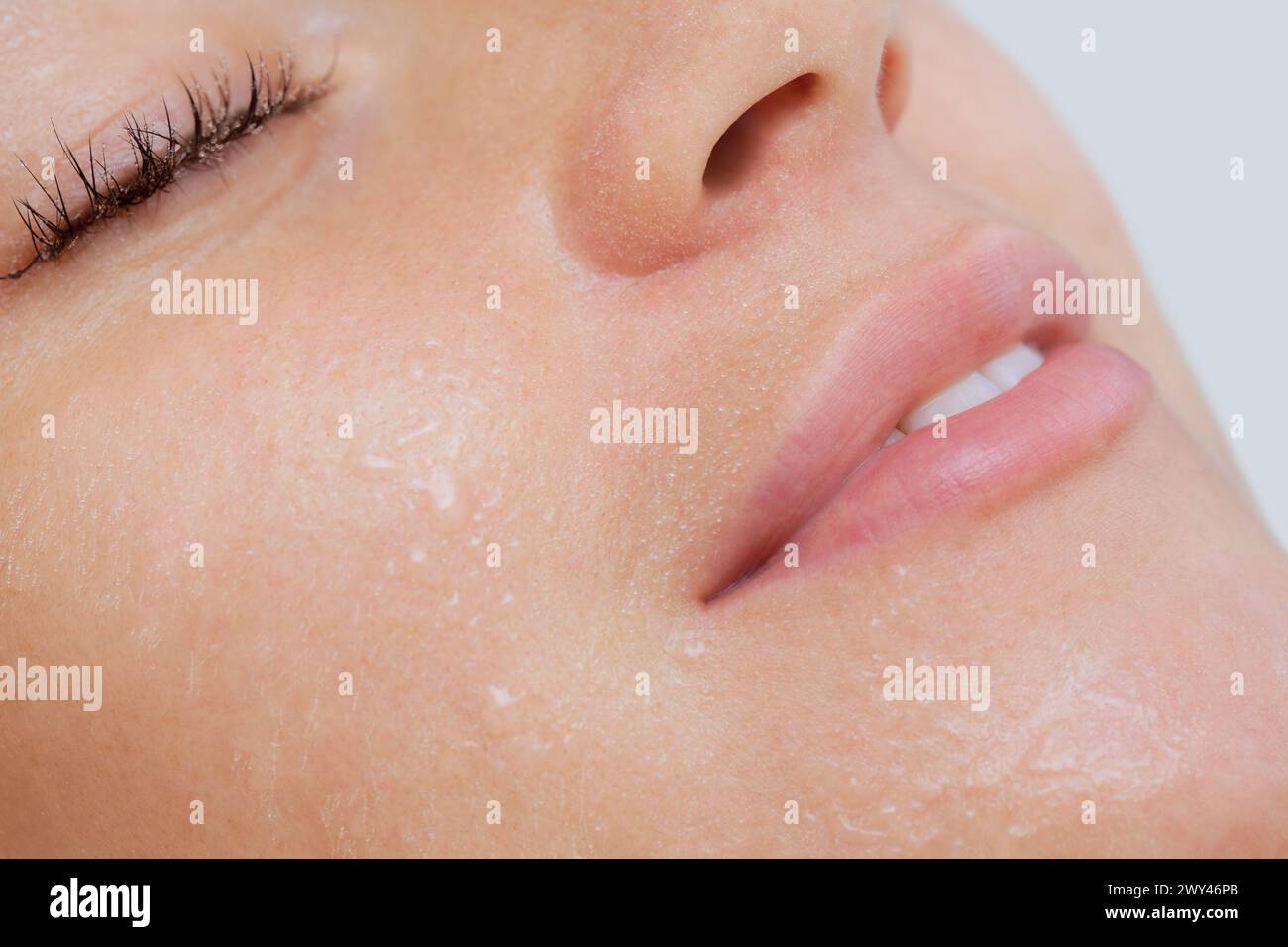 The procedure of steaming the skin of the face of a young woman before ...