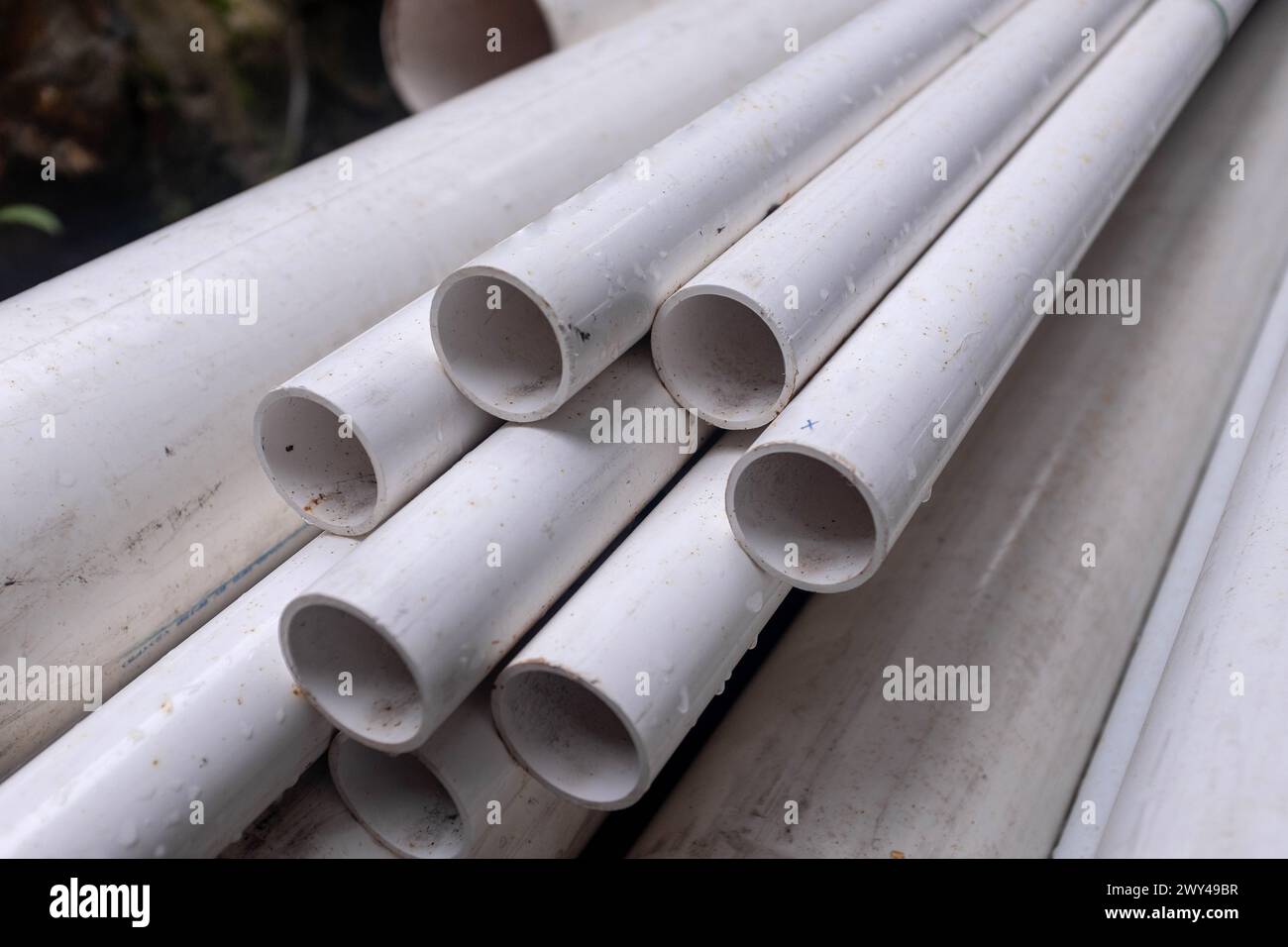 White PVC pipes ready to be installed to a new construction project ...