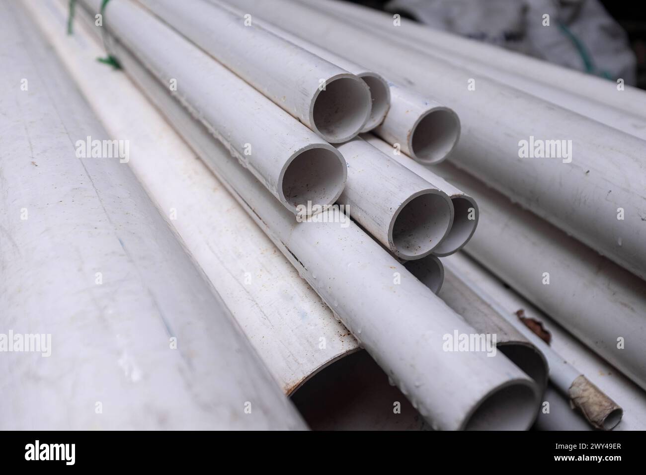 White PVC pipes ready to be installed to a new construction project ...