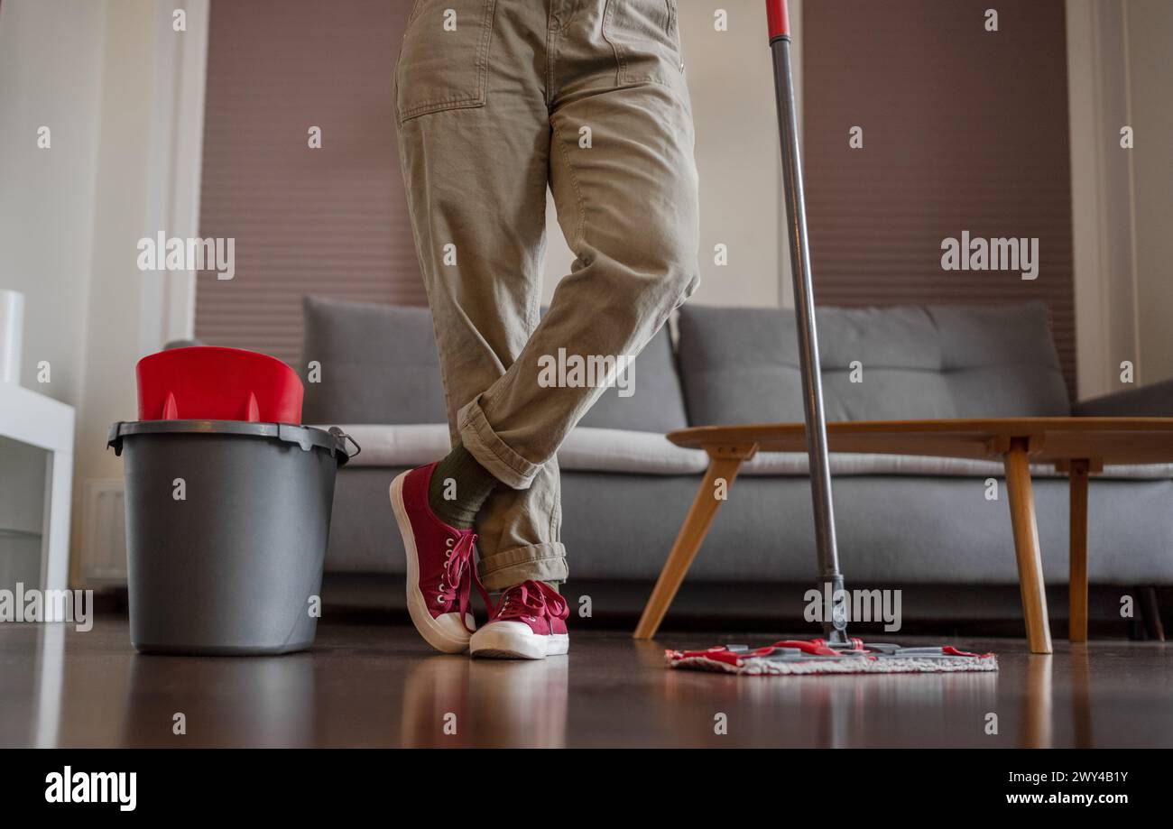 Housewife Stands With Mop In Room, Close-Up Of Face Not Visible Stock ...