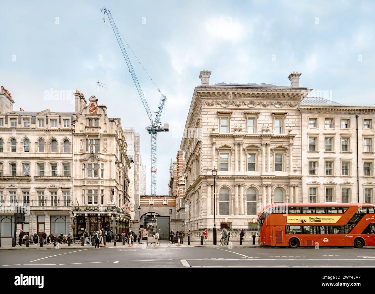 A red London bus passing by the fantastic architecture of the Red Lion ...