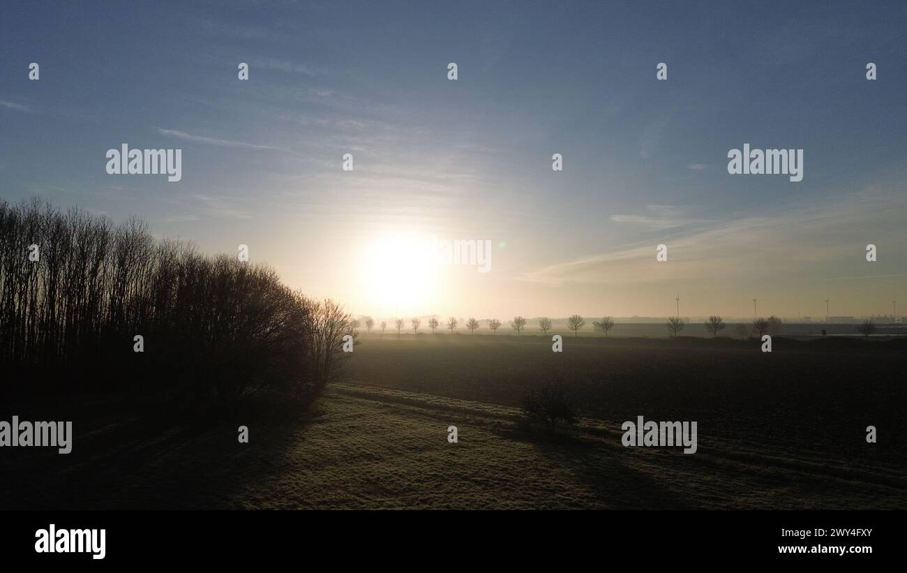 Rising sun over fields Stock Photo - Alamy