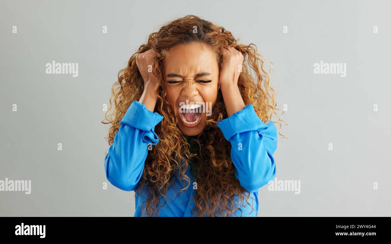 Woman, anger and screaming with depression in studio for stress, mental ...