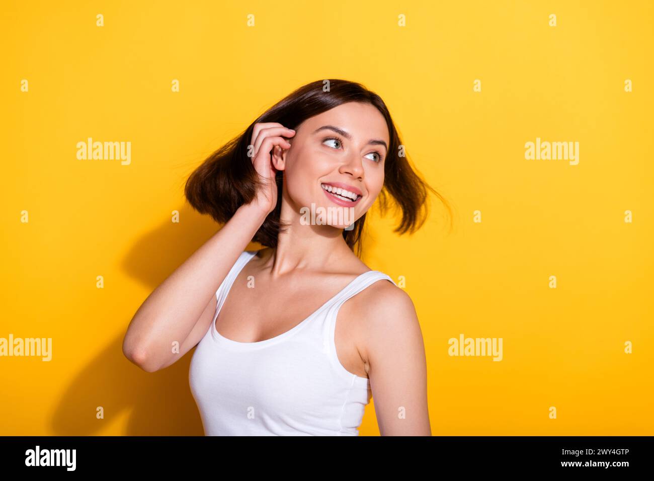 Photo portrait of attractive young girl look empty space tuck hair ...