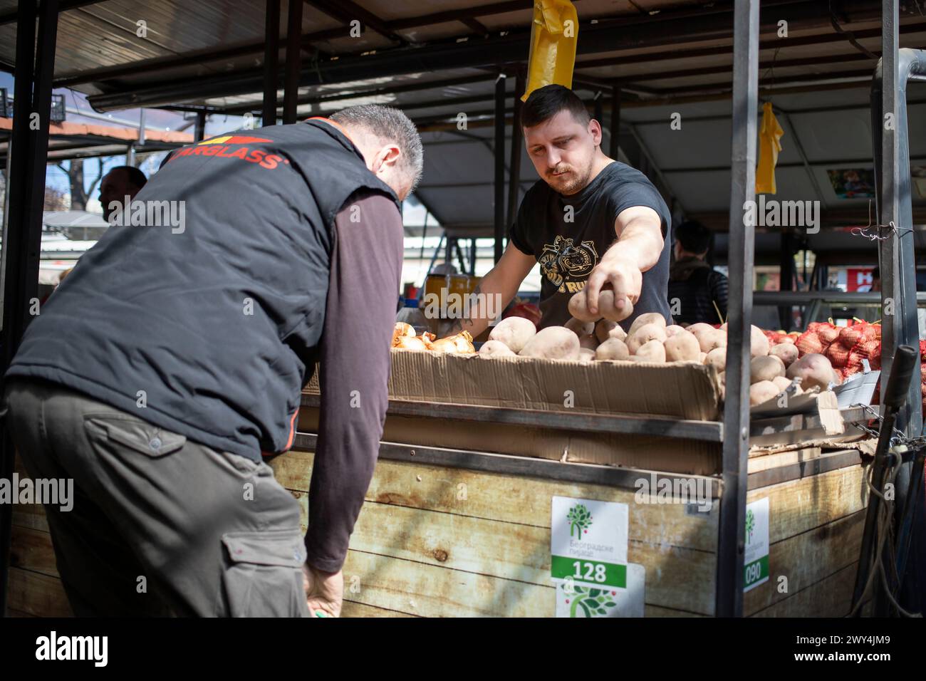 Belgrade, Serbia, Mar 23, 2024: A potato seller with a customer at the ...