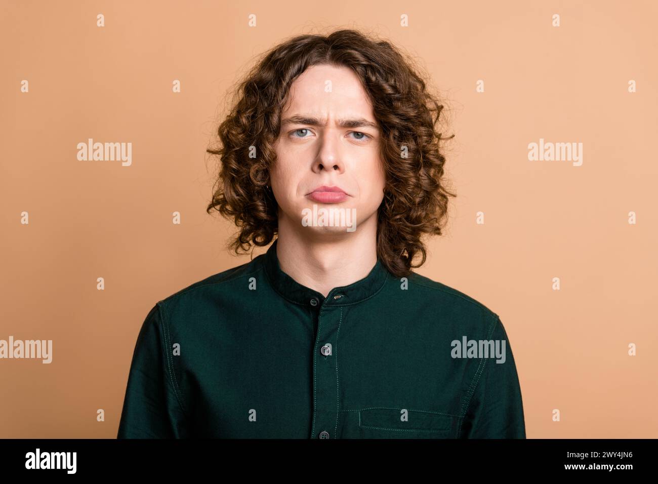 Portrait of sad upset gloomy young man wear green stylish clothes ...