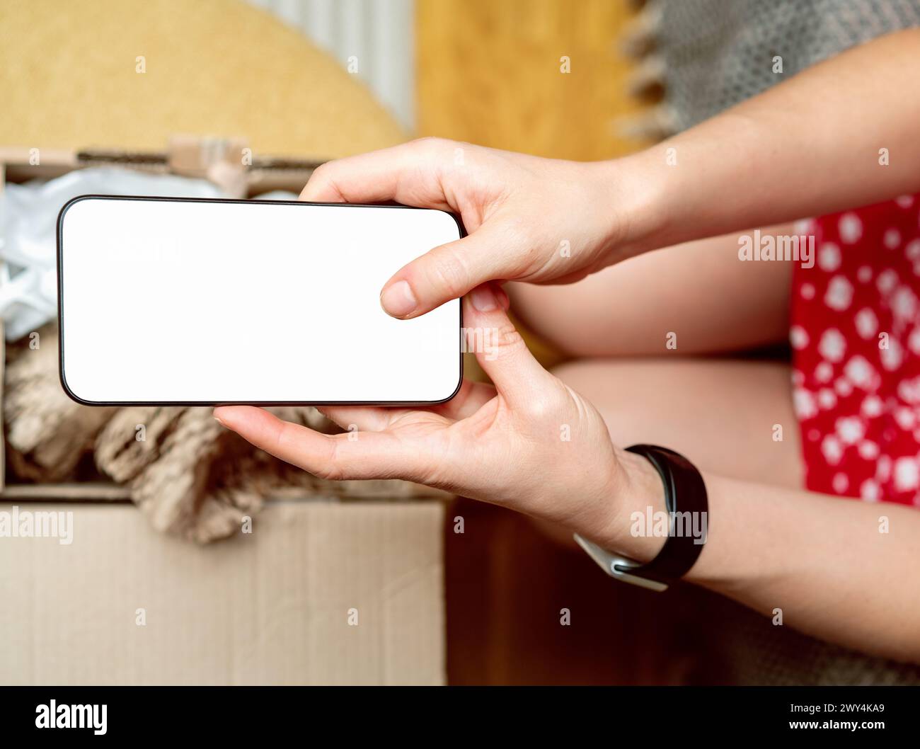 Female person customer of internet store unpacking online order and ...