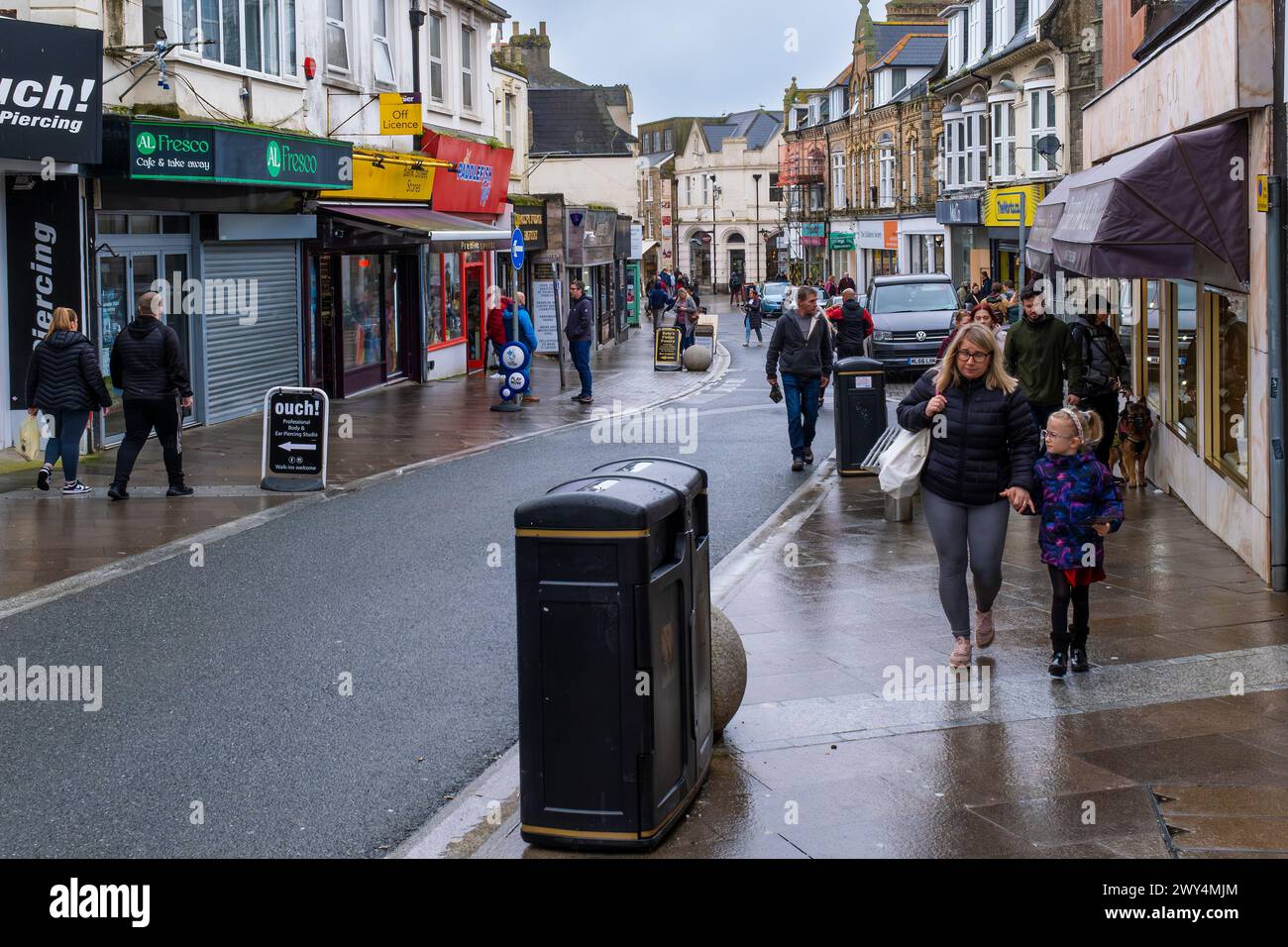UK weather; People walking through Newquay Town centre in Cornwall in ...
