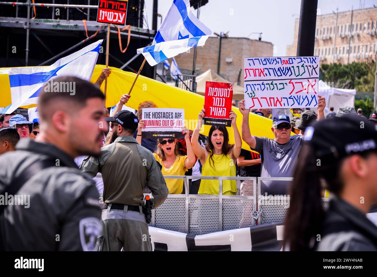 Protestors chant as they hold up signs for the hostages release in ...