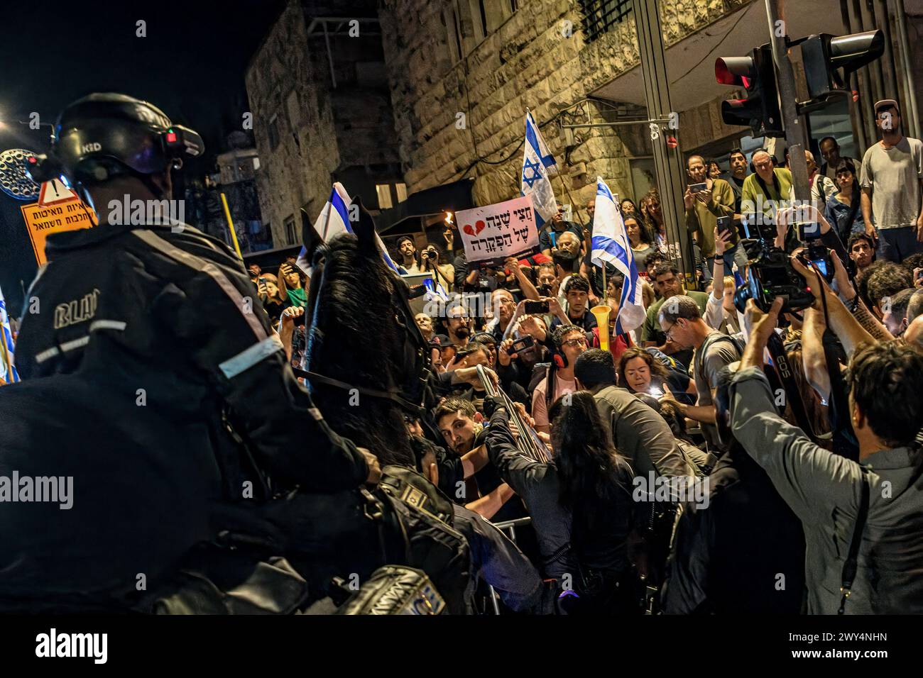 Israeli police officers push back protestors on Azza street. Thousands ...