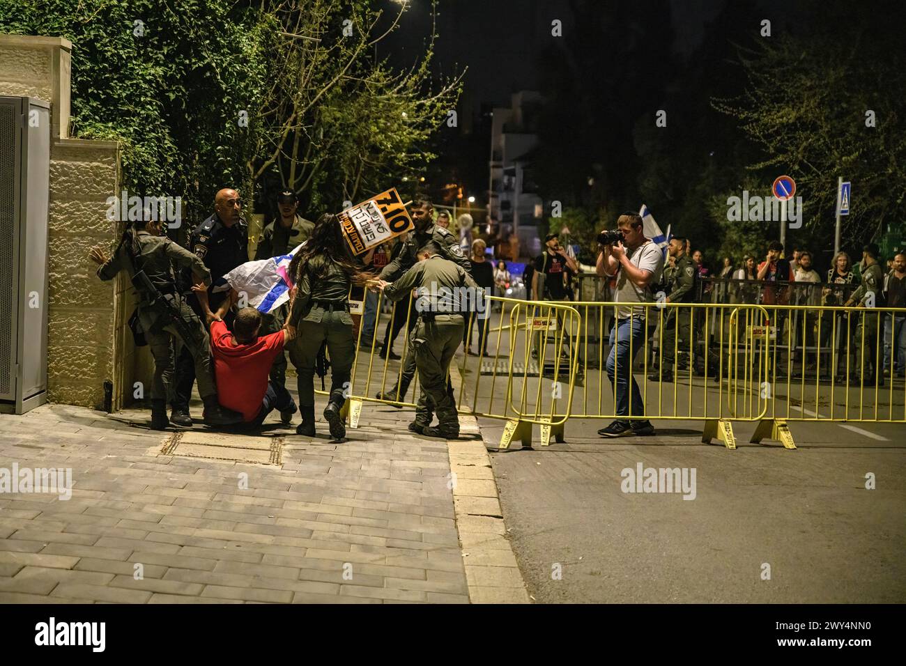Israeli border police soldiers remove a protestor beyond the police ...