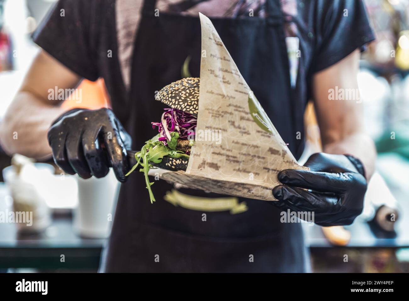 Chef serving vegetarian salmon burgers outdoor on open kitchen, odprta ...