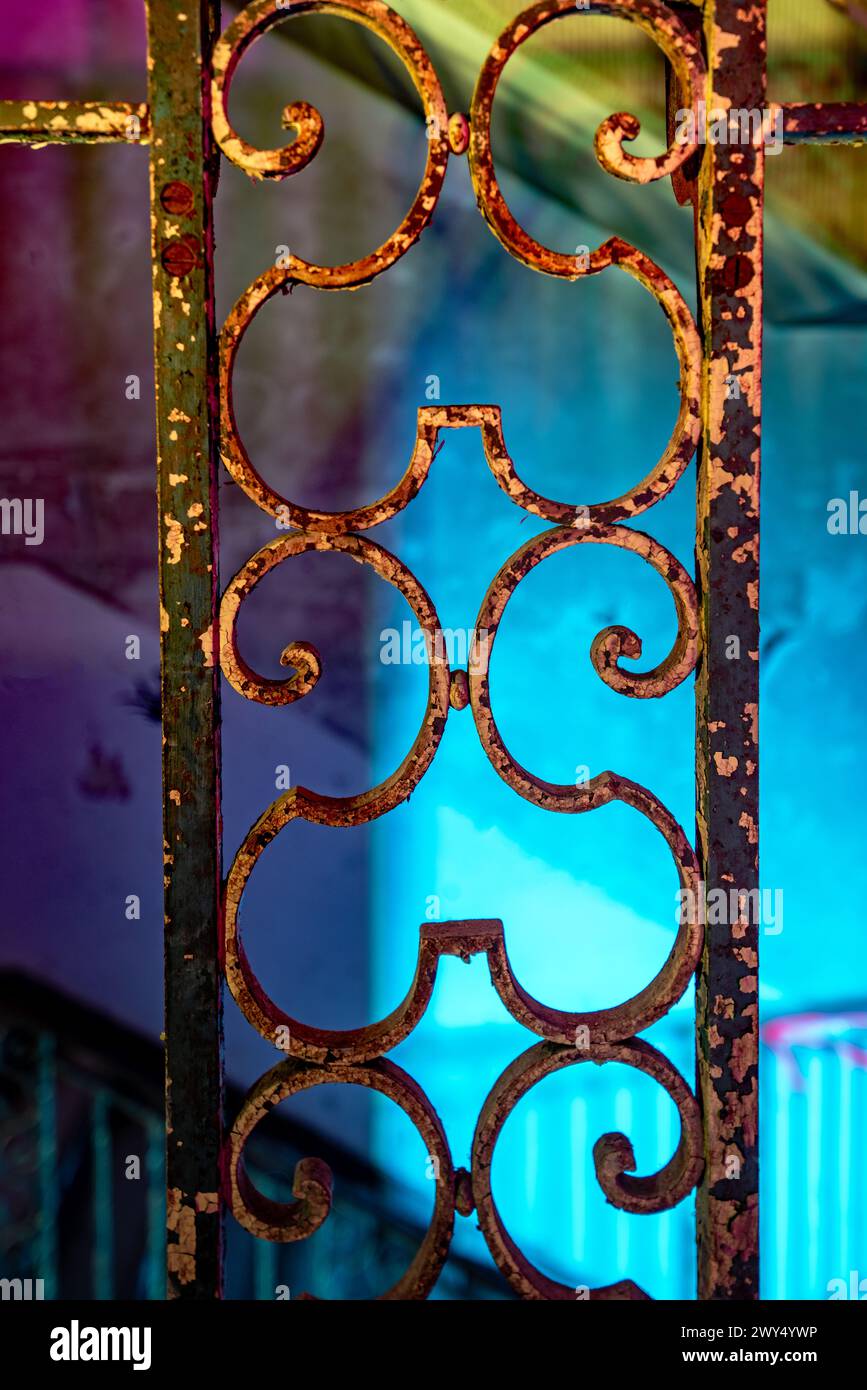 Intricate iron railing design on purple background Stock Photo - Alamy