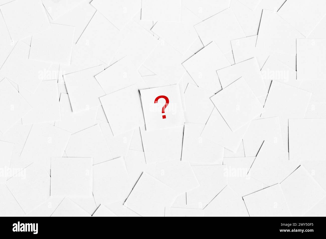 Pile of blank pieces of paper with red question mark in the middle ...